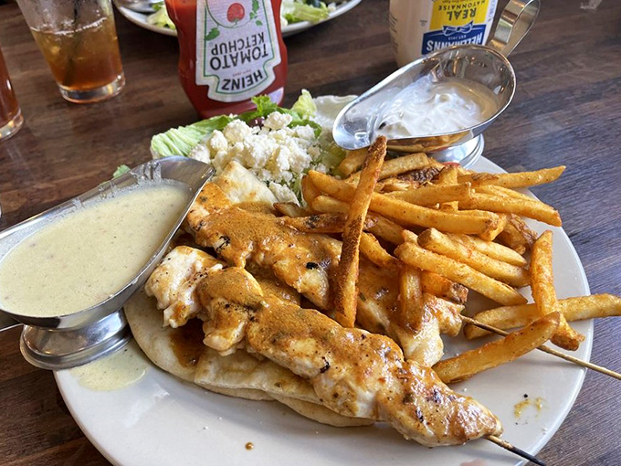 Chicken souvlaki that transports you straight to Athens – tender, herb-infused meat with fries that somehow stay crispy till the last bite.