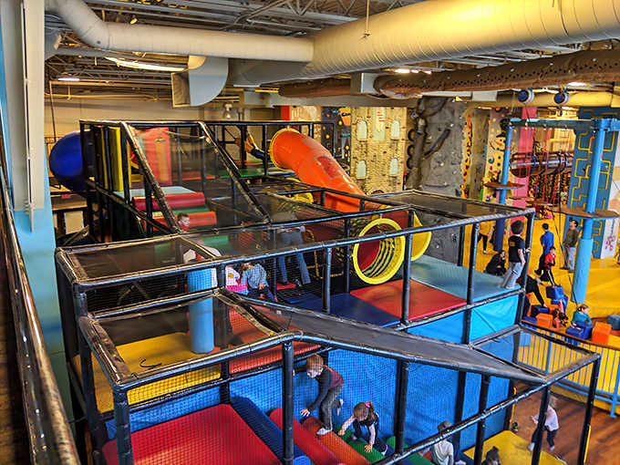 Colorful play structures create a labyrinth of fun where kids navigate tunnels and bridges in a three-dimensional maze of giggles and exploration.