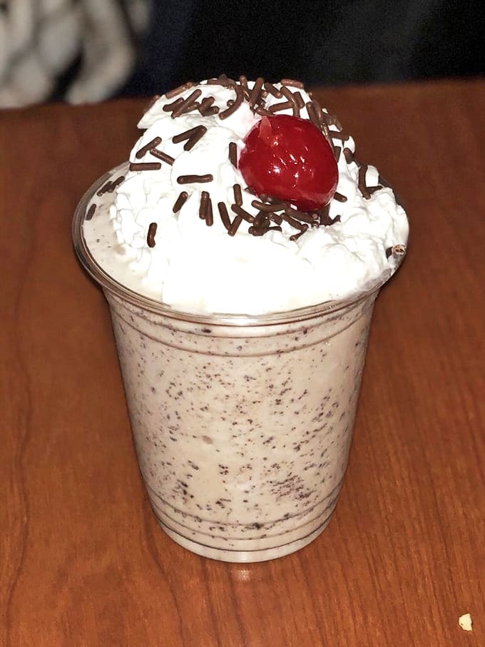 This chocolate cake shake topped with whipped cream and sprinkles is basically a birthday party in a cup.