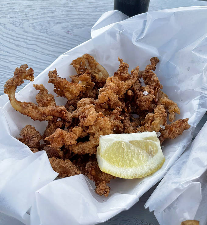 Fried clams offer a textural adventure&mdash;crispy, chewy morsels that burst with briny flavor, proving Mac's mastery extends beyond just fish.