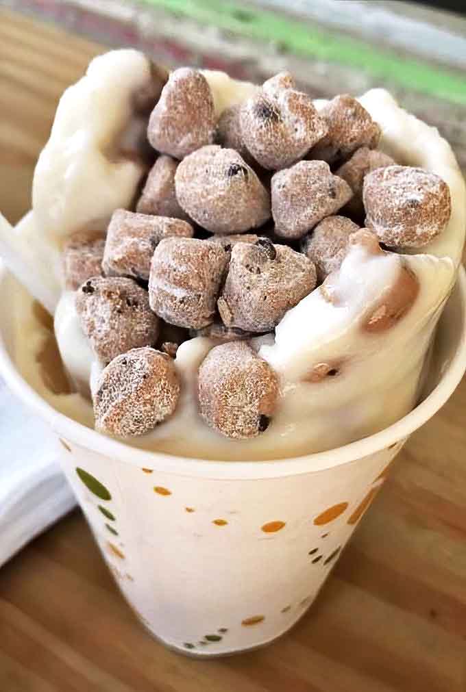 Cookie dough heaven in a cup &ndash; where chunks of unbaked bliss swim in creamy vanilla, making adults giggle with childlike delight.