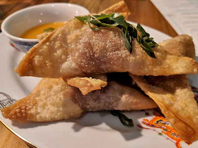 Crispy on the outside, creamy within, these crab rangoon triangles elevate the familiar appetizer with quality ingredients and perfect execution.