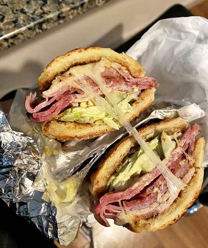 Cuban Sub: Pressed to perfection, this sandwich's crispy exterior gives way to a harmony of pork, ham, and tangy pickles.