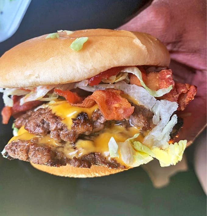 Bacon strips play hide-and-seek among melted cheese and beef &ndash; a savory treasure hunt worth every calorie.