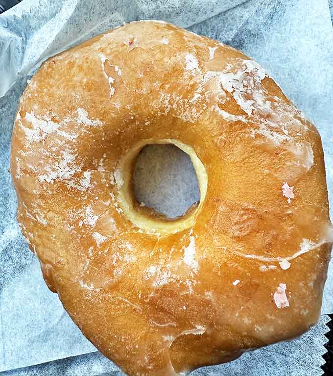 The humble glazed donut in its purest form &ndash; golden, glistening, and gloriously simple &ndash; proves that perfection needs no embellishment.