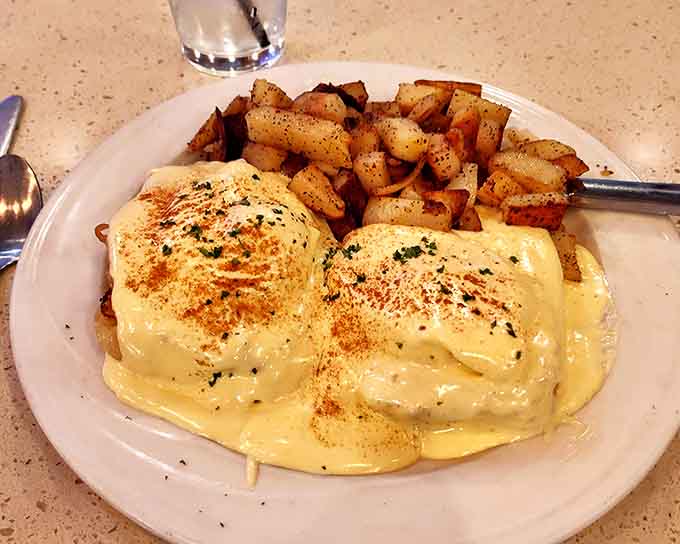 Eggs Benedict drowning in hollandaise with a side of perfectly crispy potatoes is basically breakfast royalty.