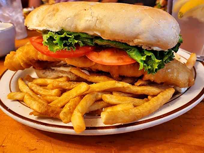 The fish sandwich that requires a game plan: crispy battered fish extending well beyond its bun borders, with fries standing by for backup.