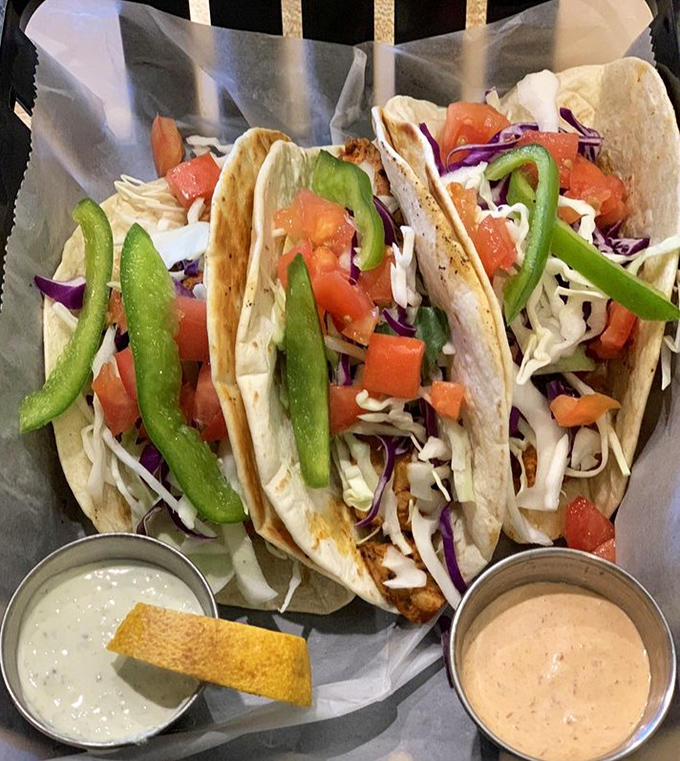 A plate of fish tacos served with not one but two dipping sauces &ndash; because sometimes decisions are hard and deliciousness shouldn't be limited.