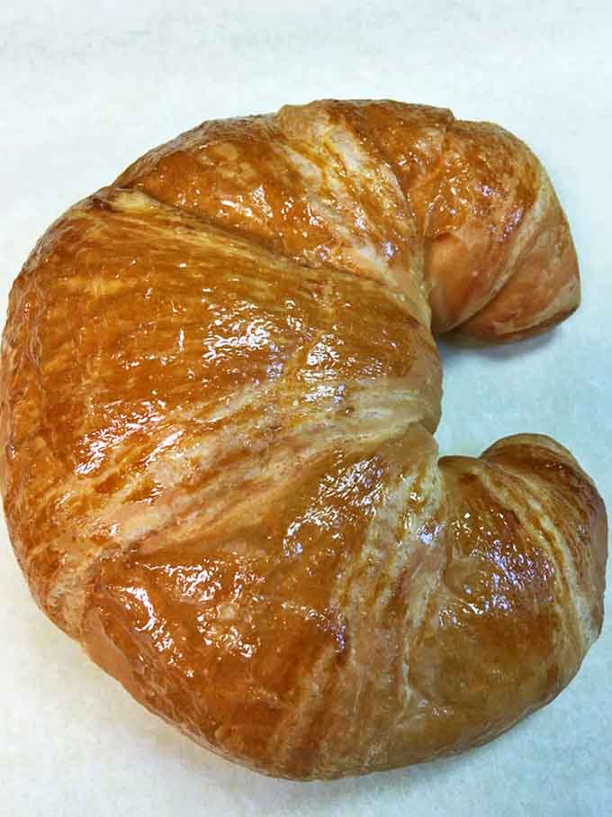 This isn't just a croissant &ndash; it's a butter-laden miracle with layers so delicate they shatter at first bite, yet sturdy enough to cradle your breakfast fillings.