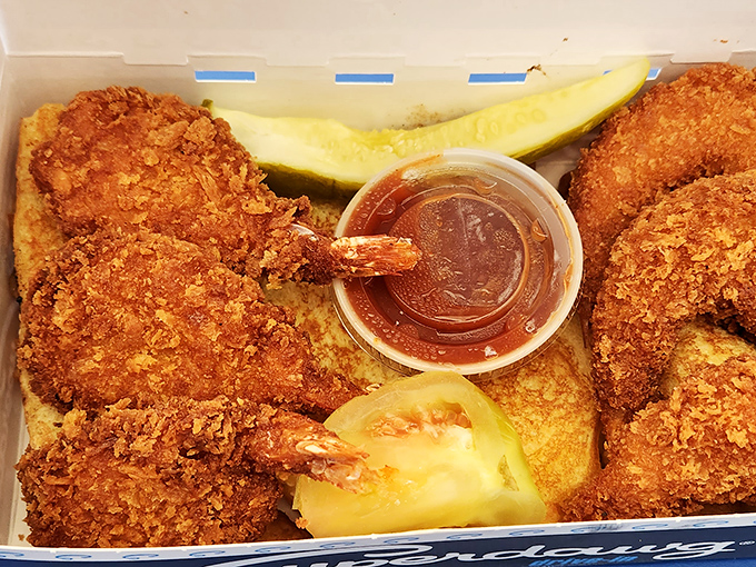Golden-battered shrimp that would make coastal seafood shacks jealous, served with a pickle for that Midwest touch.