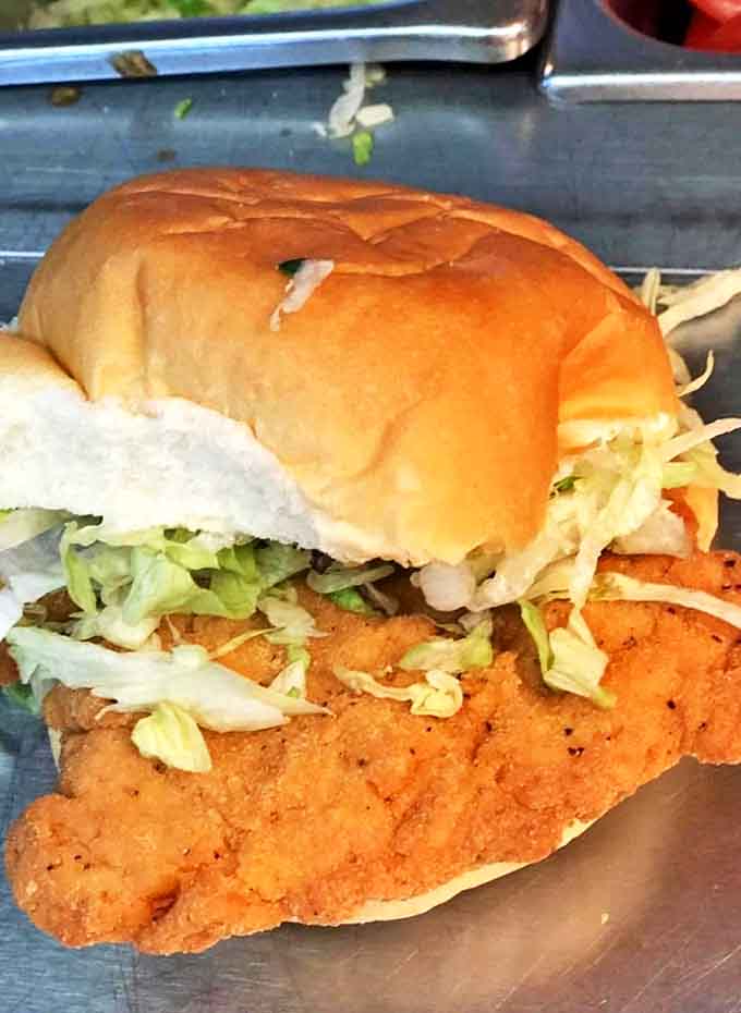 This isn't just a chicken sandwich – it's architectural perfection. The golden-fried cutlet extends beyond the bun, promising more flavor in every bite.