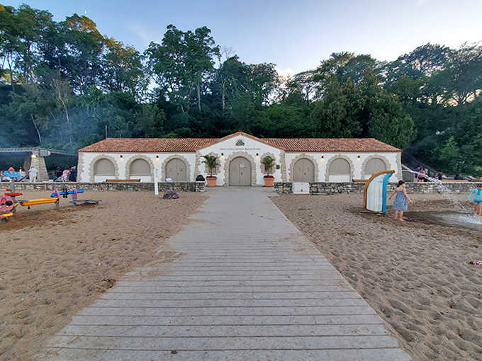 Mediterranean elegance meets Midwest practicality in Glencoe's historic beach house, its white stucco walls glowing warmly against the sandy landscape.