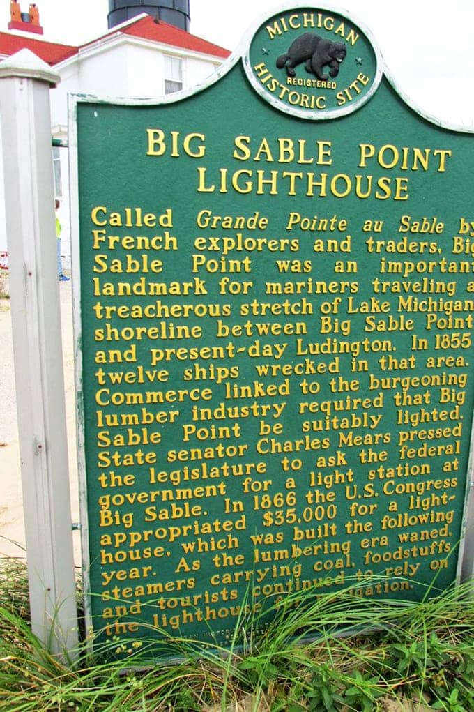 The Michigan Historic Site marker tells the tale of Grande Pointe au Sable, reminding visitors this spot has been crucial to Great Lakes navigation for centuries.
