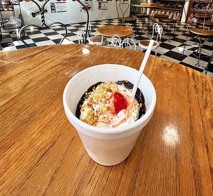 This isn't just a sundae &ndash; it's a carefully constructed monument to the art of indulgence, complete with hot fudge lava flowing down its creamy peaks.