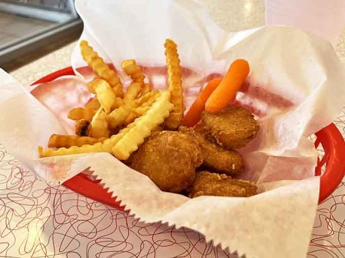 Little conductors fuel up with golden nuggets of joy, accompanied by crinkle-cut fries and a carrot for good measure.