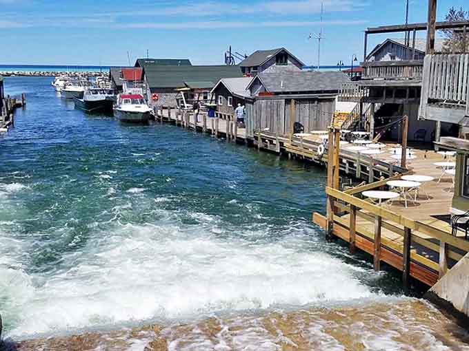 Weathered shanties stand shoulder-to-shoulder along the water, their wooden facades telling tales of storms weathered and fish caught.