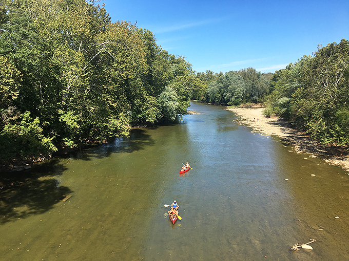 Kayakers navigate the gentle currents of the Little Miami River, nature's own lazy river without the theme park prices.