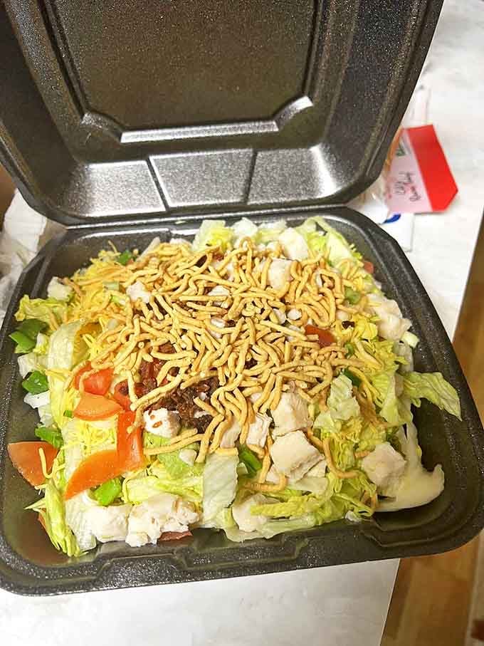 The Chicken Chopped Salad offers a refreshing counterpoint to pizza indulgence. Crisp vegetables, tender chicken, and crunchy toppings create a symphony of textures and flavors.