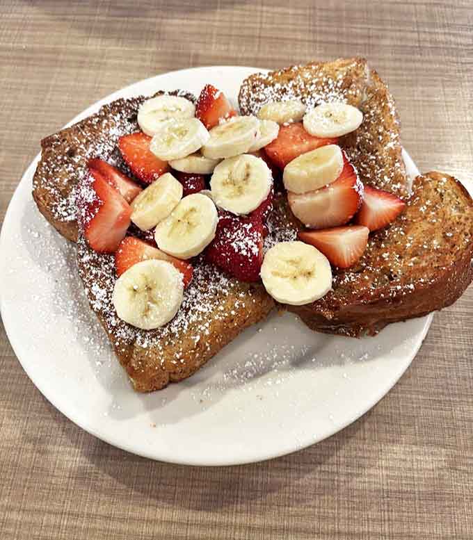 Bread transformed into morning magic, topped with fresh fruit that makes you feel virtuous about essentially eating dessert for breakfast.