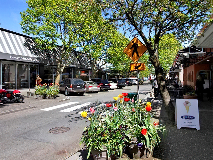 Main Street blooms with seasonal color. Notice how the pedestrians stroll rather than rush—that's the Kirkland pace of life.