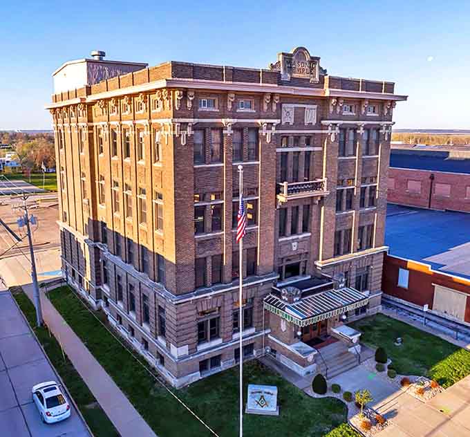 The Masonic Temple rises six impressive stories, its imposing brick fa&ccedil;ade a testament to the craftsmanship and civic pride of early 20th century Quincy.