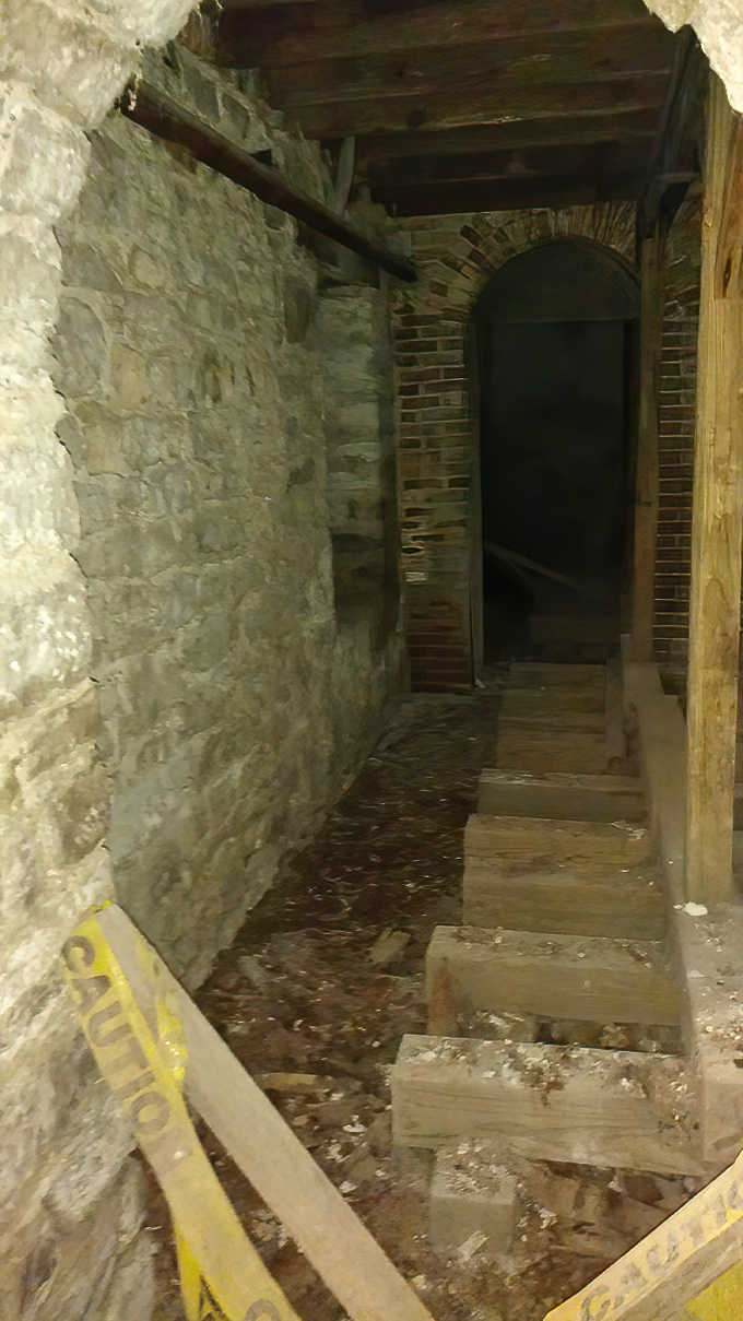 Stone walls and rough-hewn beams frame this passageway where temperature drops happen faster than stock market crashes.