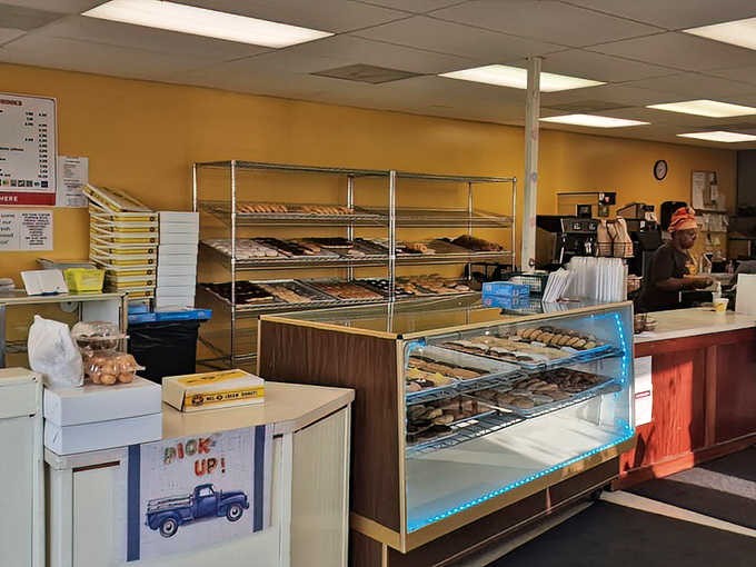 Behind the counter, where donut magic happens daily, shelves of freshly made treasures await their destiny in the hands of eager customers.