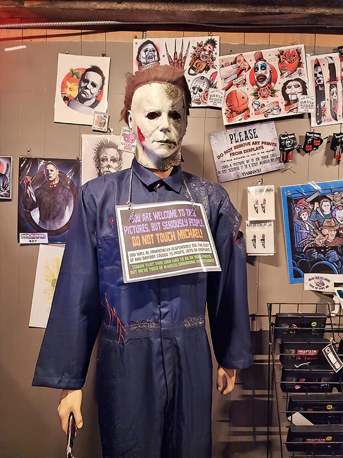 Michael Myers: The Shape himself, standing silently among horror memorabilia. That blank stare somehow feels more unnerving under fluorescent lights than in any darkened hallway.