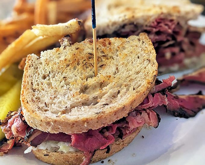 The Montreal-style smoked meat sandwich showcases thinly sliced, perfectly spiced beef on rye &ndash; simple ingredients elevated to art form.