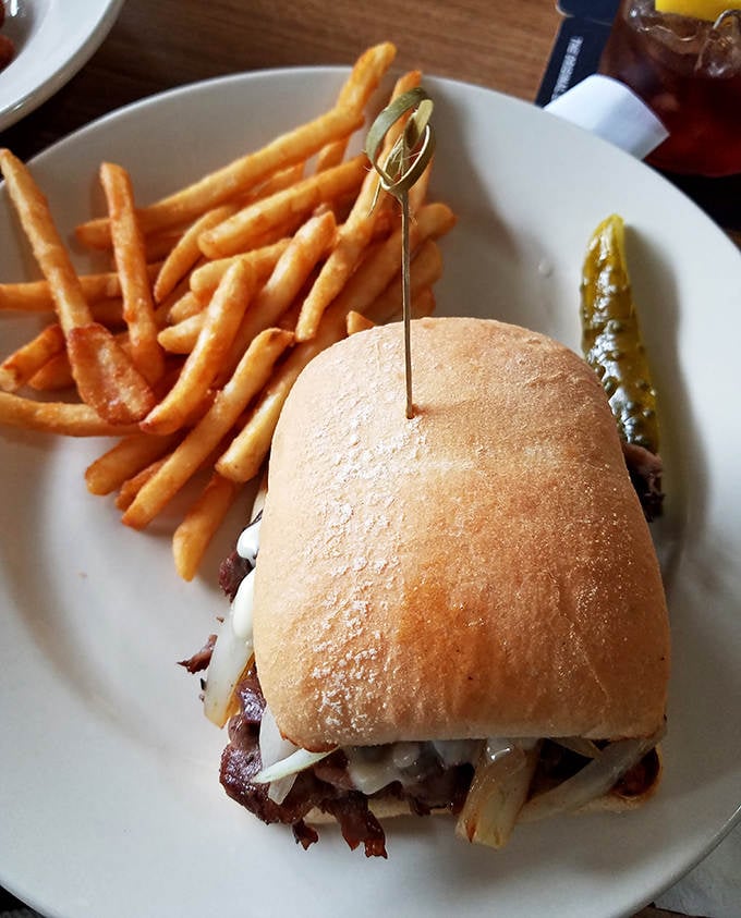 A sandwich that demands two hands and your full attention. The combination of tender meat, melty cheese, and fresh bread creates edible harmony.