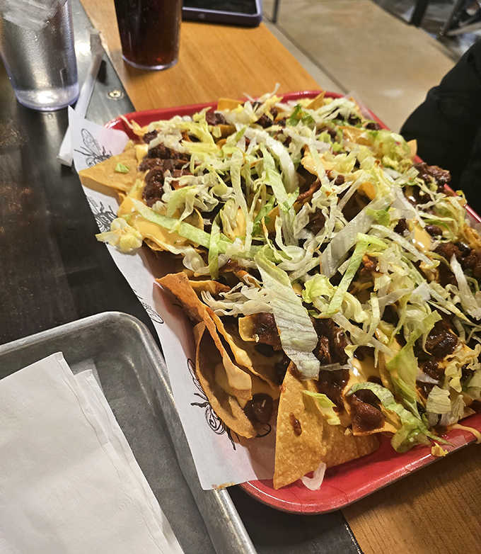 A mountain of tortilla chips buried under an avalanche of BBQ goodness, where every dig reveals new treasures beneath.