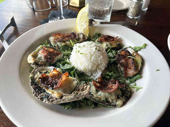 Oysters Rockefeller arrive bubbling hot, their spinach-cheese topping creating a decadent blanket over plump oysters &ndash; seafood comfort food at its finest.