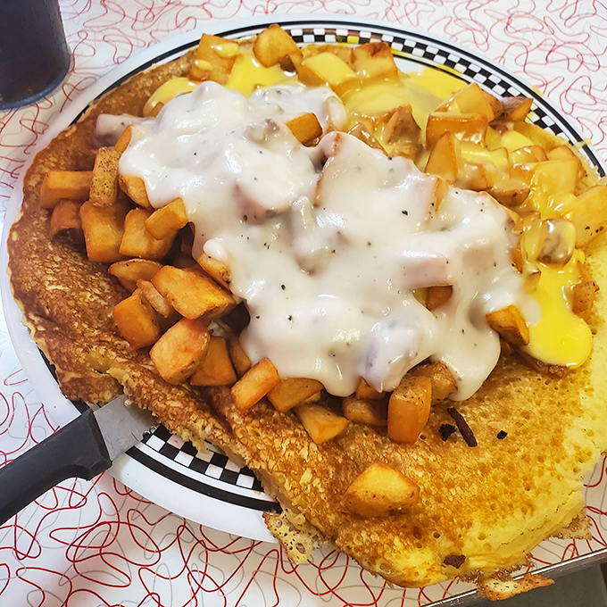 French toast transformed into an architectural marvel &ndash; golden bread foundations supporting a mountain of potatoes under a cheese sauce waterfall.