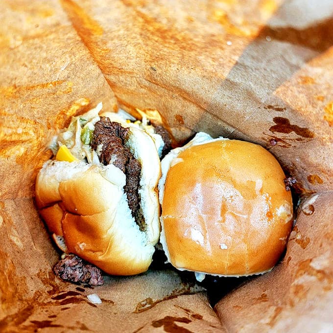 The humble paper bag &ndash; nature's most perfect burger delivery system. That grease spot? That's what happiness looks like in takeout form.