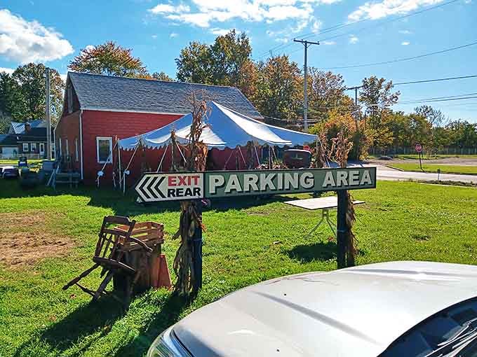 Follow the arrow to parking paradise, where that tent promises outdoor treasures and the red barn holds even more vintage delights.