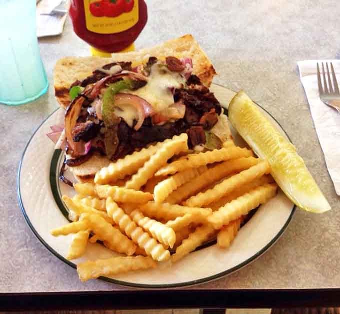 A proper Philly - tender beef, melted cheese, and the perfect ratio of peppers and onions with crispy fries.