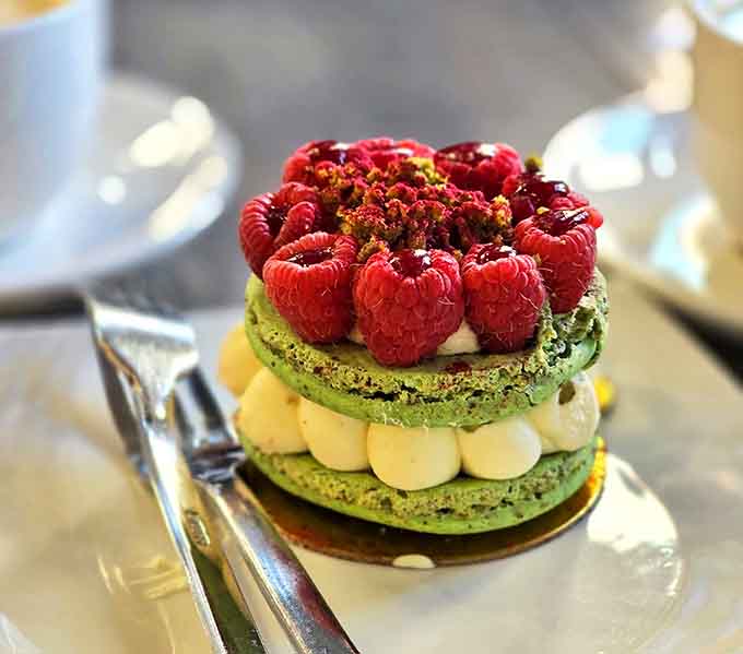 The pistachio raspberry macaron looks like it should be in a museum, but tastes like it should be ordered by the dozen.