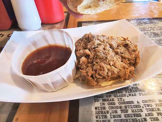 This pulled pork slider isn't just a sandwich – it's a tender, smoky revelation that fits in your palm but looms large in your food memories.