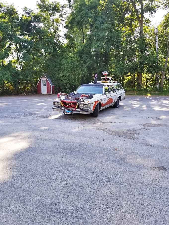 A post-apocalyptic station wagon serves as both warning and welcome sign for those brave enough to enter.