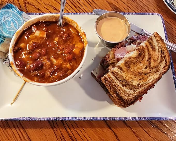 The Reuben sandwich towers impressively next to hearty chili, creating a lunch-meets-breakfast combo that'll fuel you through whatever adventures await.