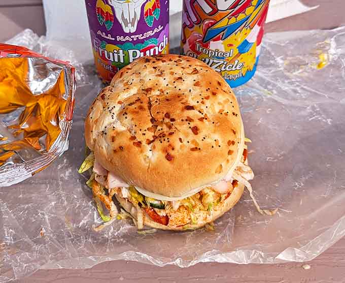 The take-out packaging is engineered for maximum sandwich security, ensuring your meaty masterpiece arrives home intact and ready for consumption, napkins strongly recommended.