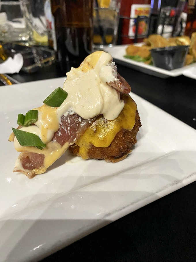 Golden-fried spheres of joy topped with cheese sauce and green onions &ndash; like sophisticated tater tots that went to culinary school.
