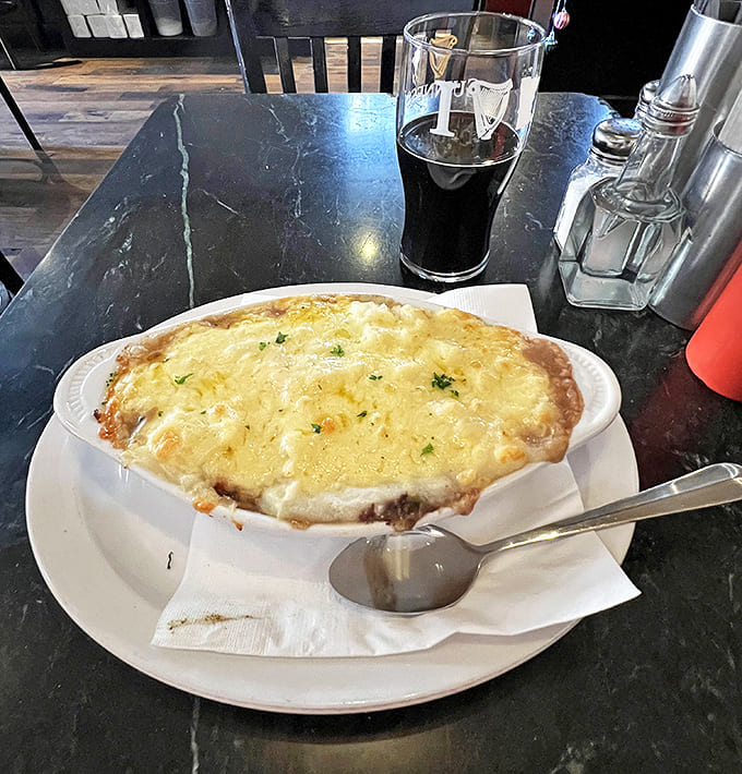 A perfect pairing: the rich, hearty Shepherd's Pie alongside a properly poured pint of dark Irish beer.
