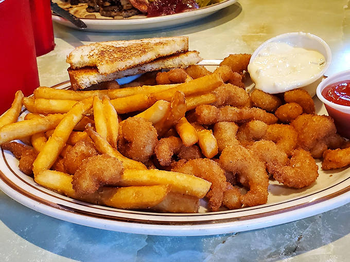 Golden-fried shrimp and crispy fries – simple pleasures executed perfectly, proving fancy plating is no match for honest-to-goodness flavor.