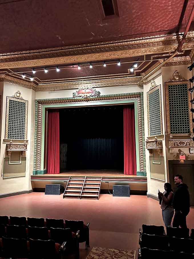 Ornate architectural details frame the Riviera's stage, where the red curtain promises to reveal anything from classic films to live performances.