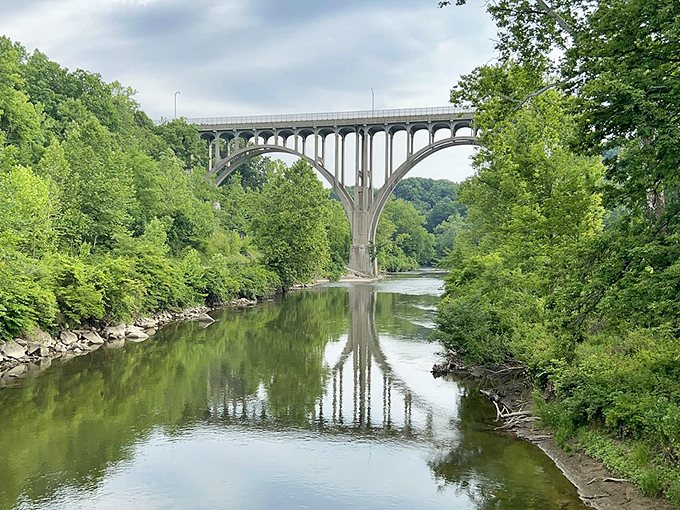 Station Road Bridge arches gracefully over the Cuyahoga River, reflecting in waters that once caught fire but now nurture life.