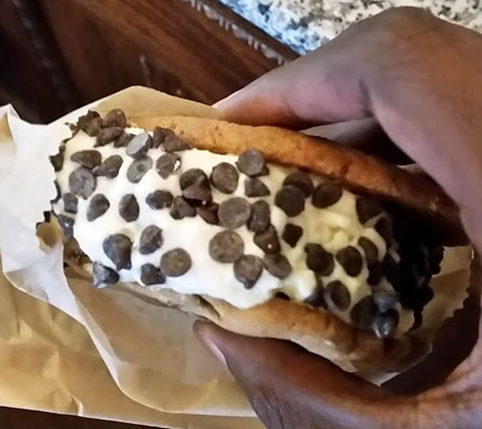 Ice cream sandwiched between actual cookies and rolled in chocolate chips, because mediocrity is not an option here.