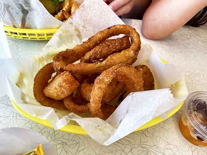 These aren't just onion rings – they're golden halos of happiness with the perfect crunch-to-squish ratio that lesser rings can only dream about.