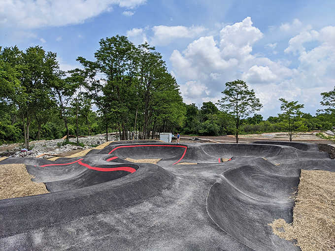 The pump track's smooth curves and berms transform casual cyclists into temporary BMX professionals with minimal embarrassment.