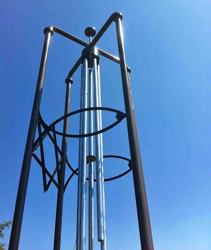 Looking up from directly below, the chime's geometric patterns create a mesmerizing kaleidoscope effect against the blue Illinois sky.